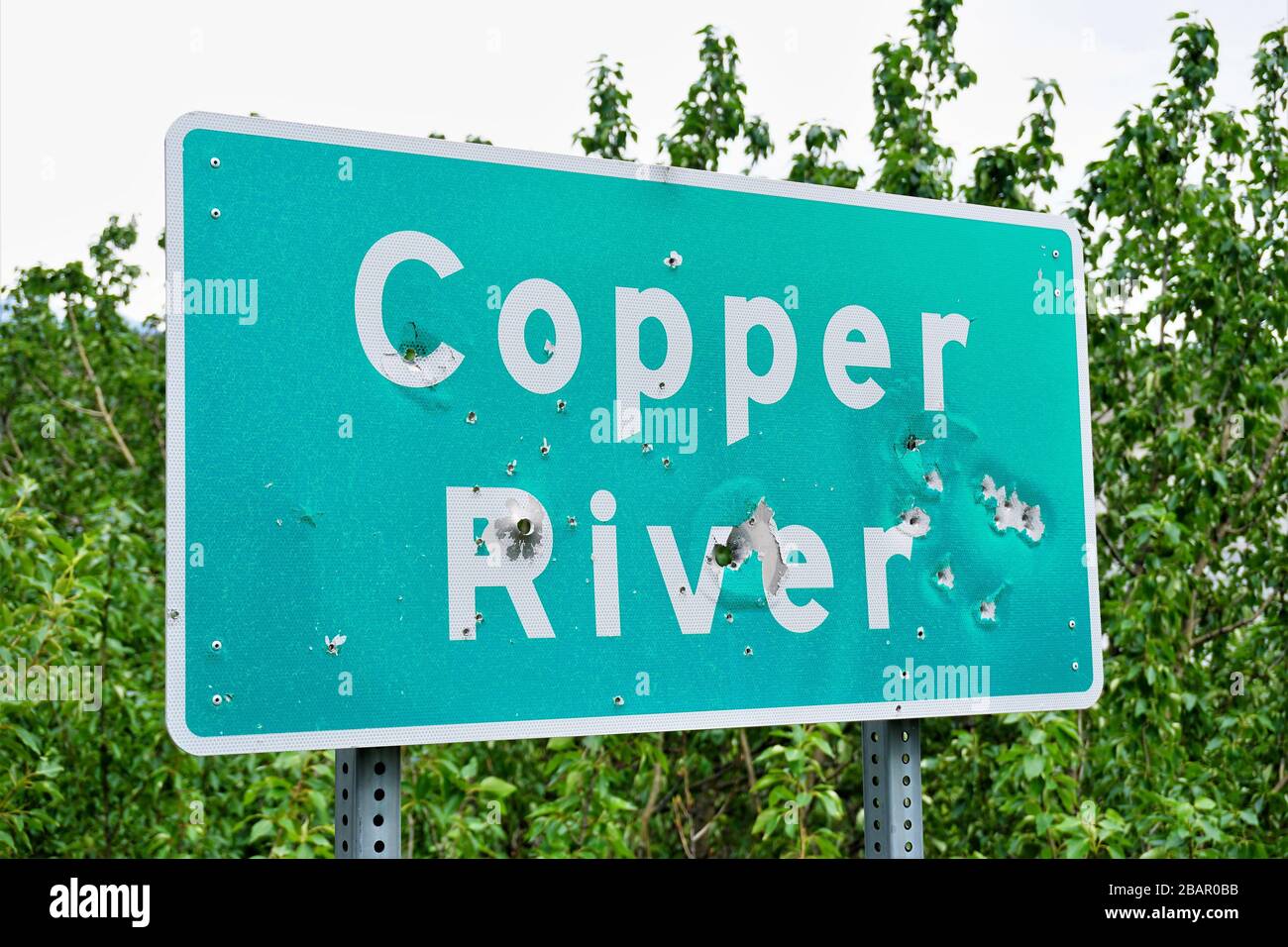 Traffic sign Copper River with lots of bullet holes Stock Photo - Alamy