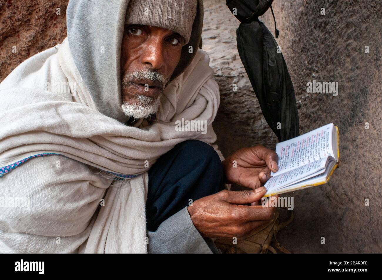 Priest reading the bible, Lalibela, Ethiopia, Africa. Bete Giyorgis and ...