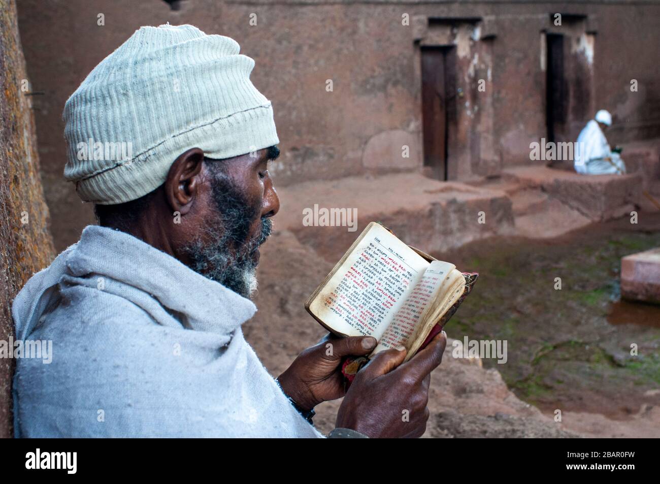 Priest reading the bible, Lalibela, Ethiopia, Africa. Bete Giyorgis and ...