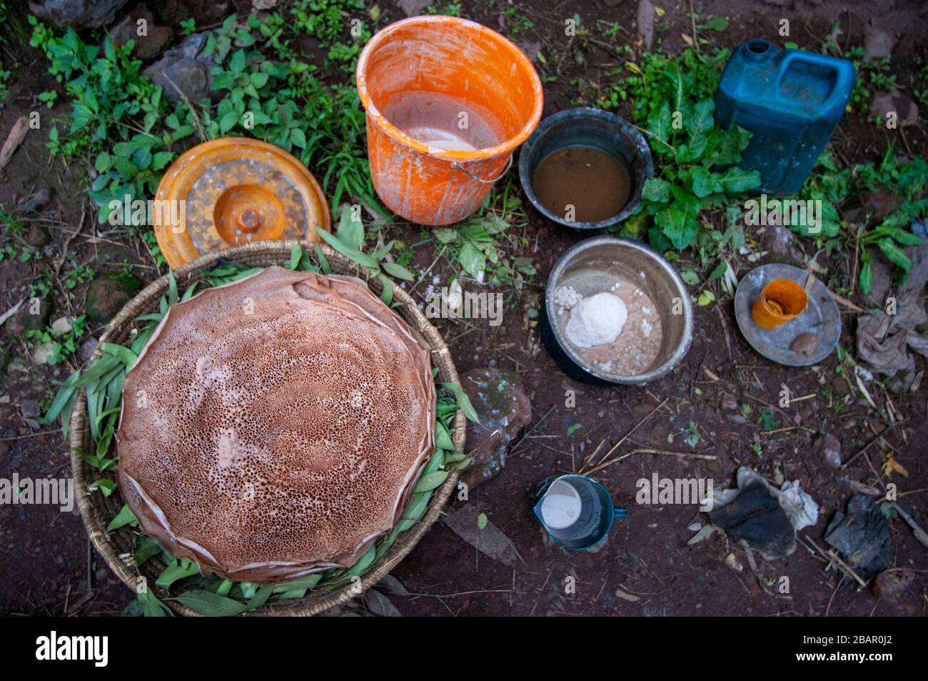 Woman cooking Injera pancake like bread on a mogogo over a fire ...