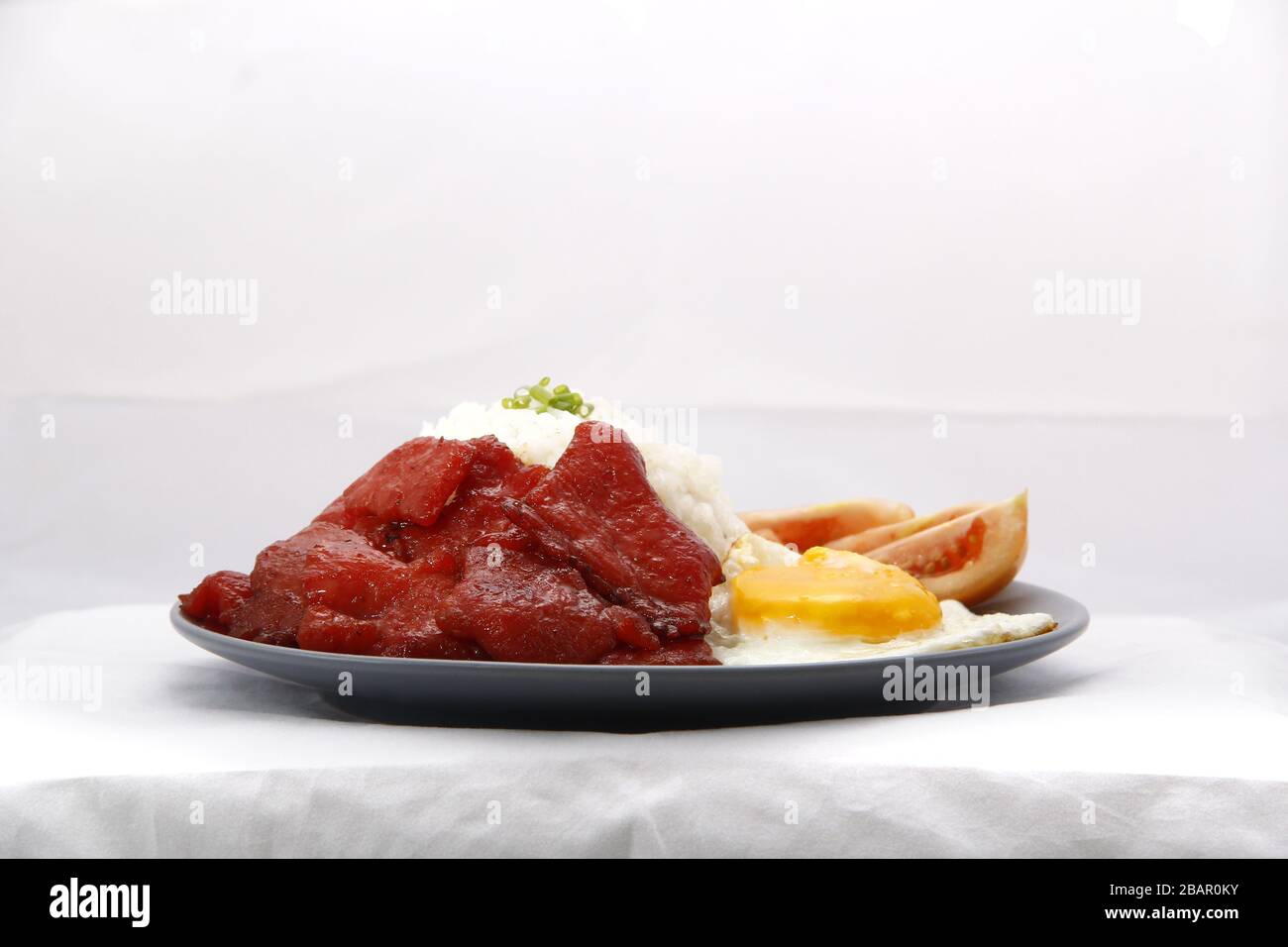 Photo of freshly cooked Tocino or cured pork meat served with fried ...