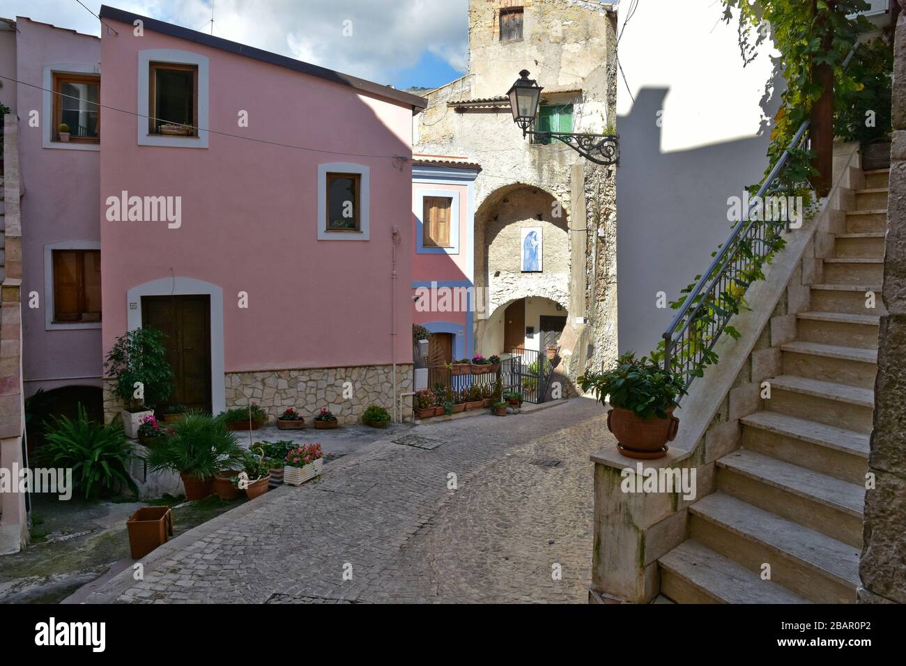 A narrow street between the stone houses of Maranola, a medieval ...