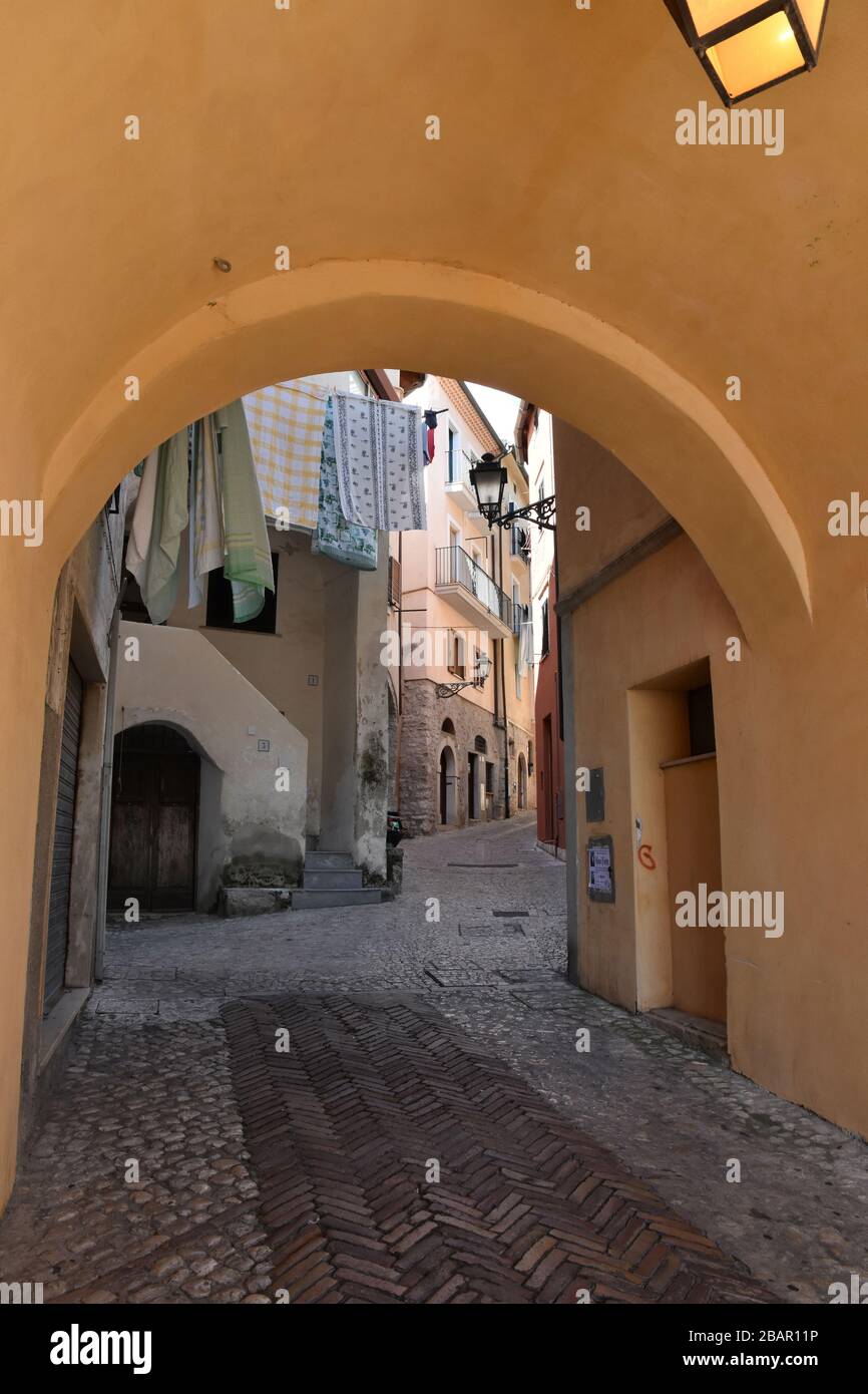 Maranola, Italy. A narrow street between the old houses of a medieval ...