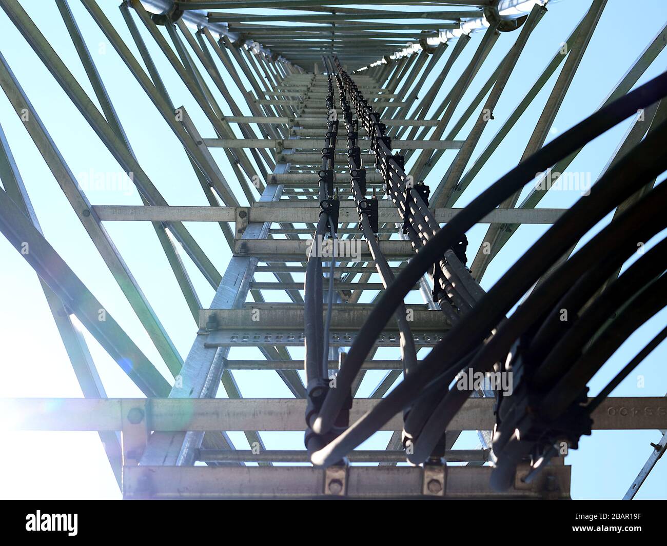 The photograph offers an upward perspective of a telecommunications ...