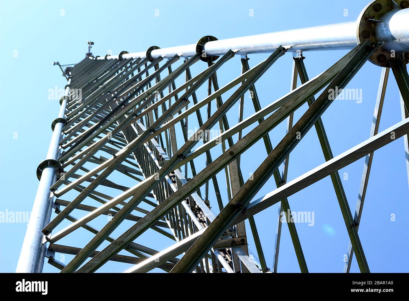 This ground-level photograph depicts the intricate steel framework of a ...