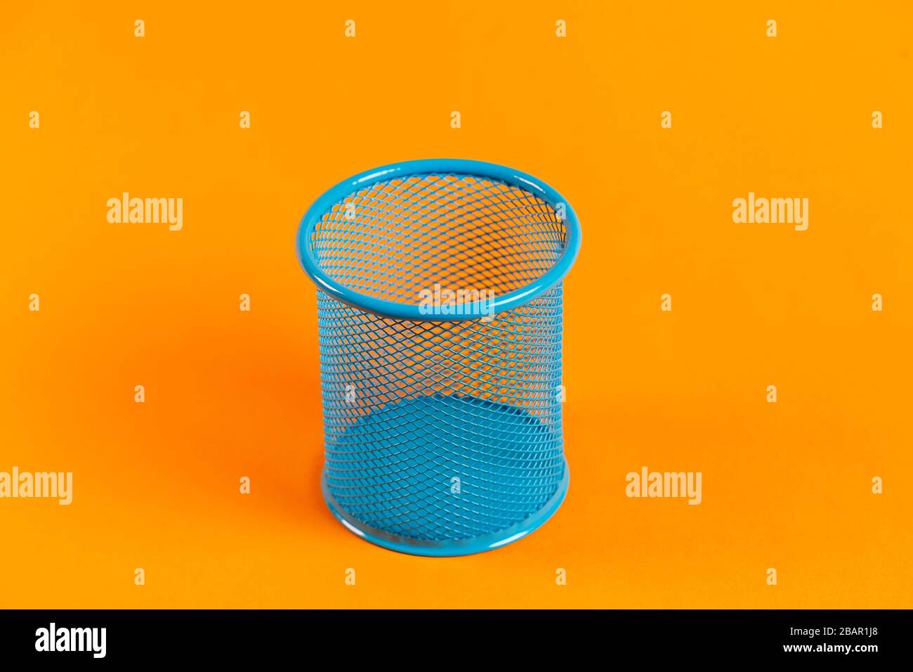 blue metal bucket for office on an orange background Stock Photo - Alamy