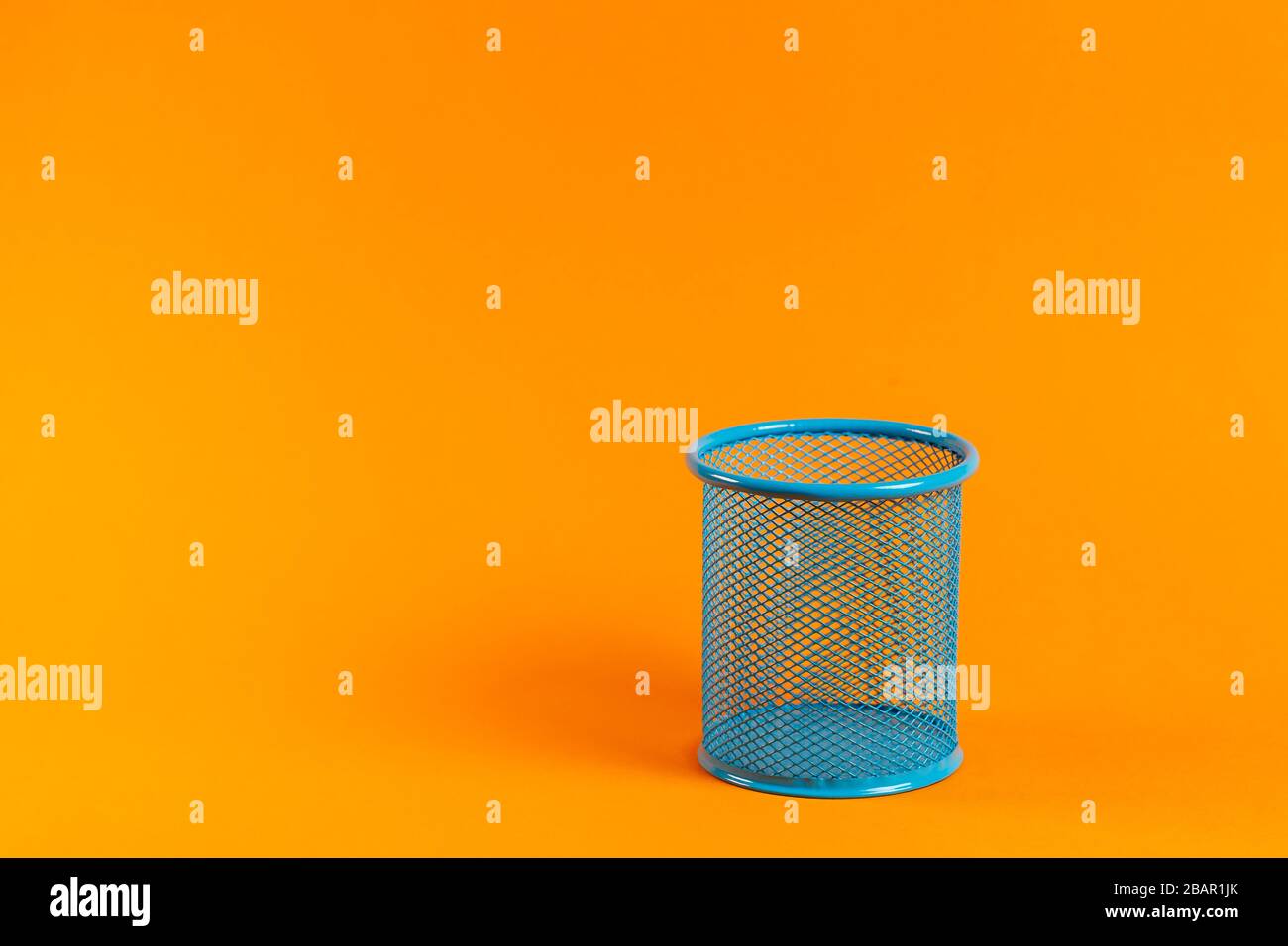 blue metal bucket for office on an orange background Stock Photo - Alamy
