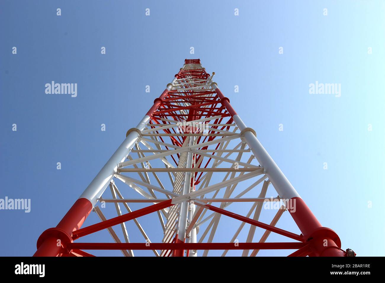 This ground-level photograph depicts the intricate steel framework of a ...