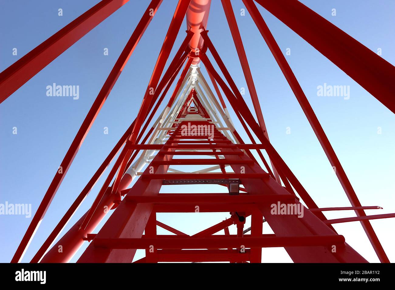 The photograph offers an upward perspective of a telecommunications ...