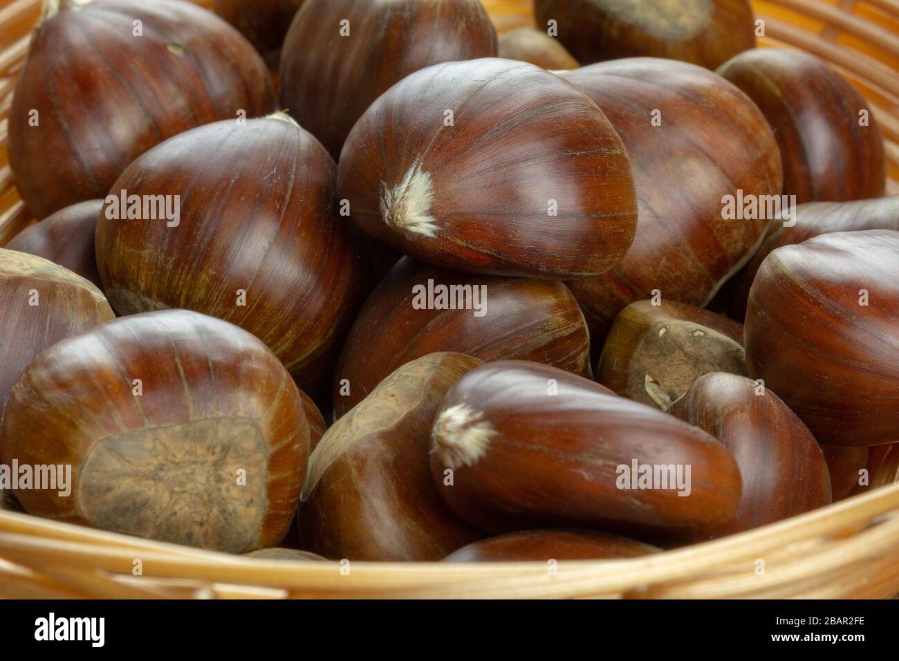 fresh sweet chestnut fruits in a basket closeup Stock Photo - Alamy