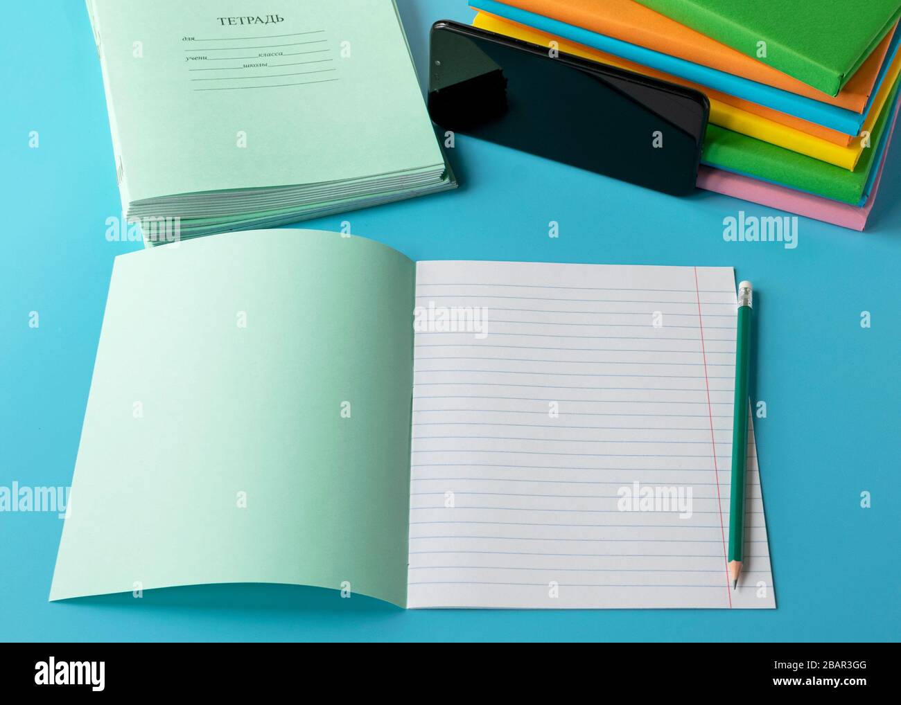 Distance Learning Concept. Pile of books, notebook, pencil, mobile ...