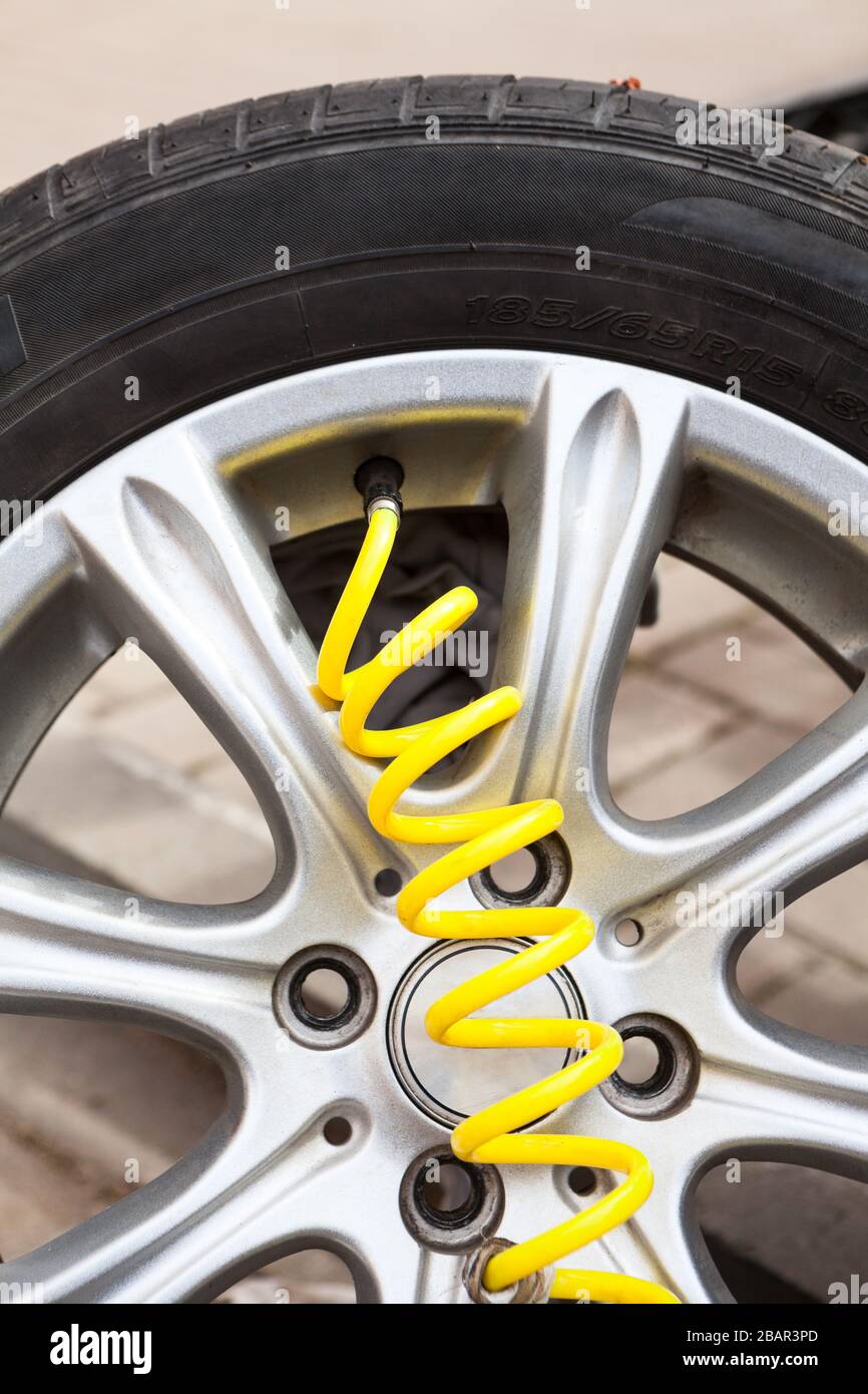 Close up view at yellow hose of pneumatic pump connected to valve core ...