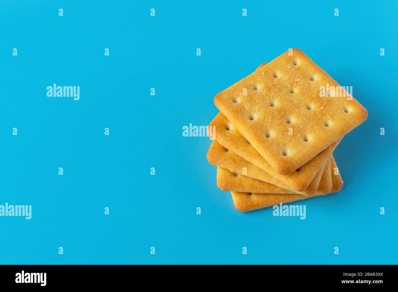 Crispy cracker on a blue background. Salty tea biscuits. Healthy Diet ...