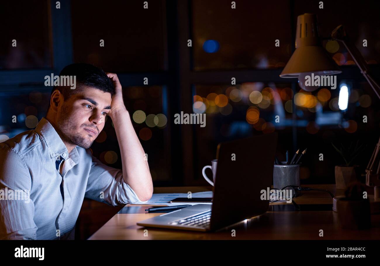 Thoughtful Businessman At Laptop Thinking Overnight Sitting In Office ...