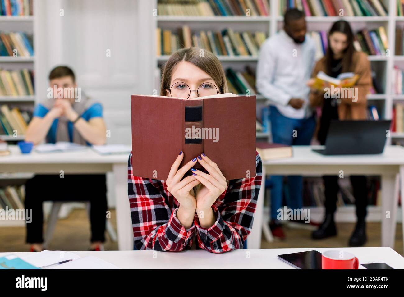 High school, education and people concept. Pretty student girl hiding ...