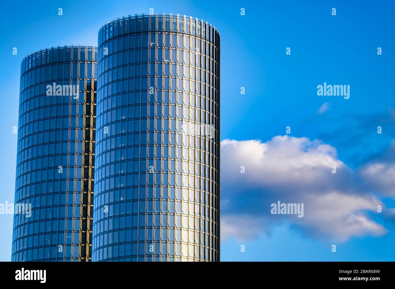 A skyscraper against a blue sky with clouds Stock Photo - Alamy