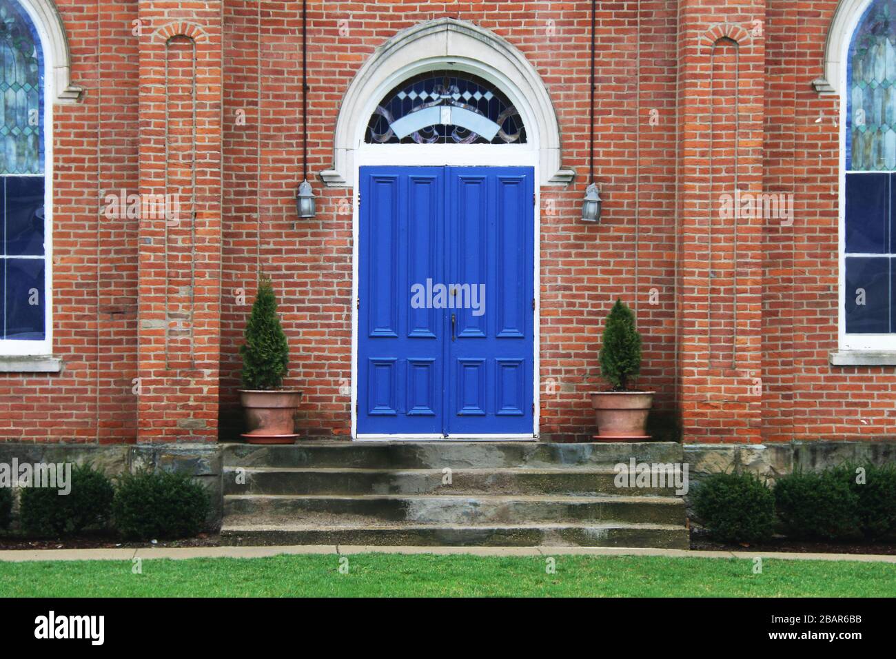 a pair of beautiful blue doors on a vintage old brick church Stock ...
