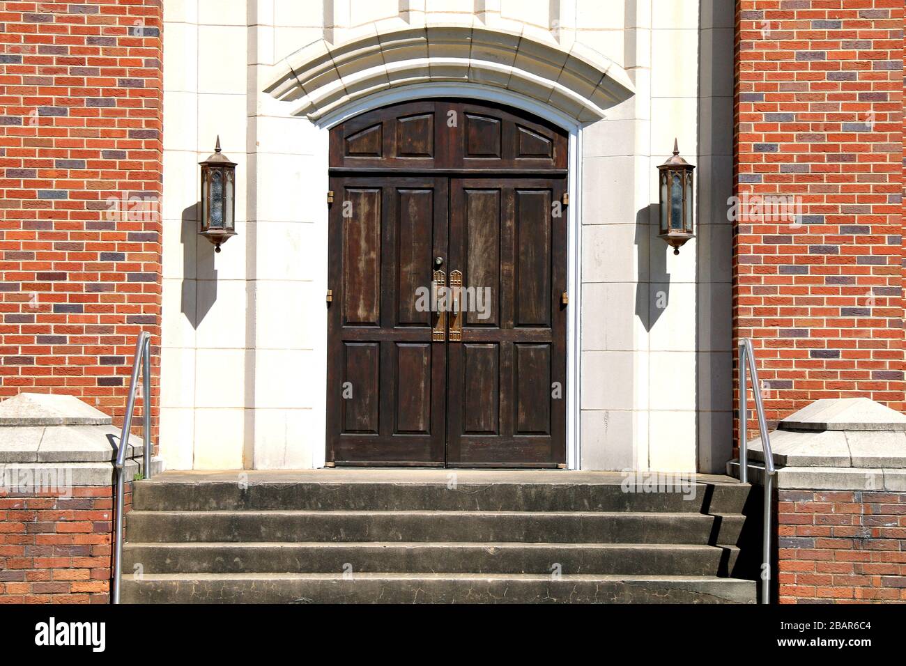 a set of old stone church wood doors and brick steps Stock Photo - Alamy