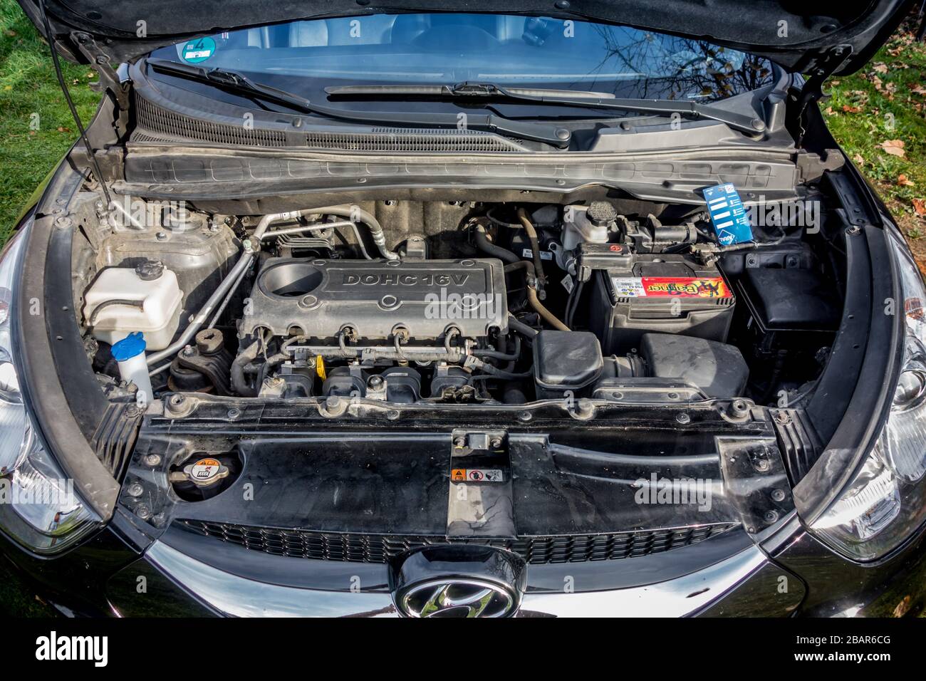 Car with hood cracked up/opened - engine repair by mechanic. Engine ...