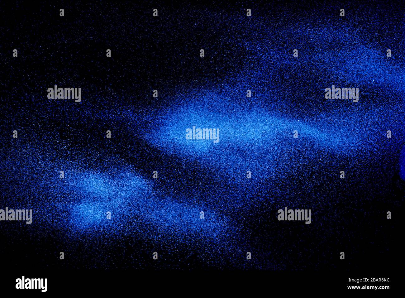 Blue color dust particles explosion cloud on black background.Color ...