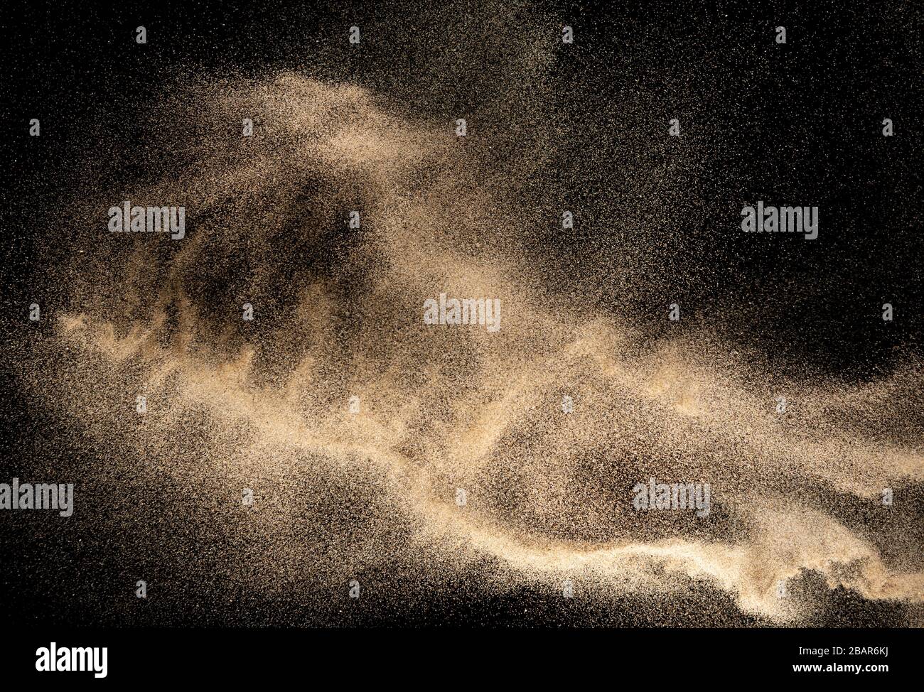 Brown colored sand splash.Dry river sand explosion isolated on black ...