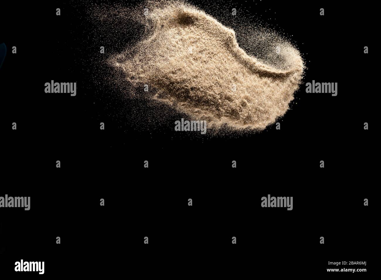 Brown colored sand splash.Dry river sand explosion isolated on black ...