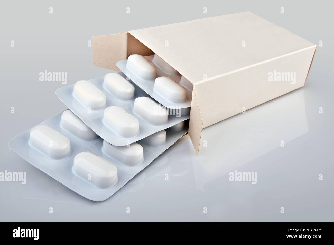 Pills blister getting out from the box over Gradient background with ...