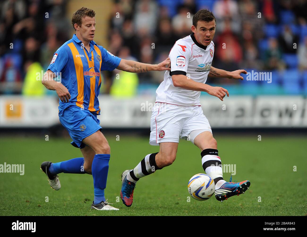 Walsall's Andy Butler (right) and Shrewsbury Town's Paul Parry battle ...