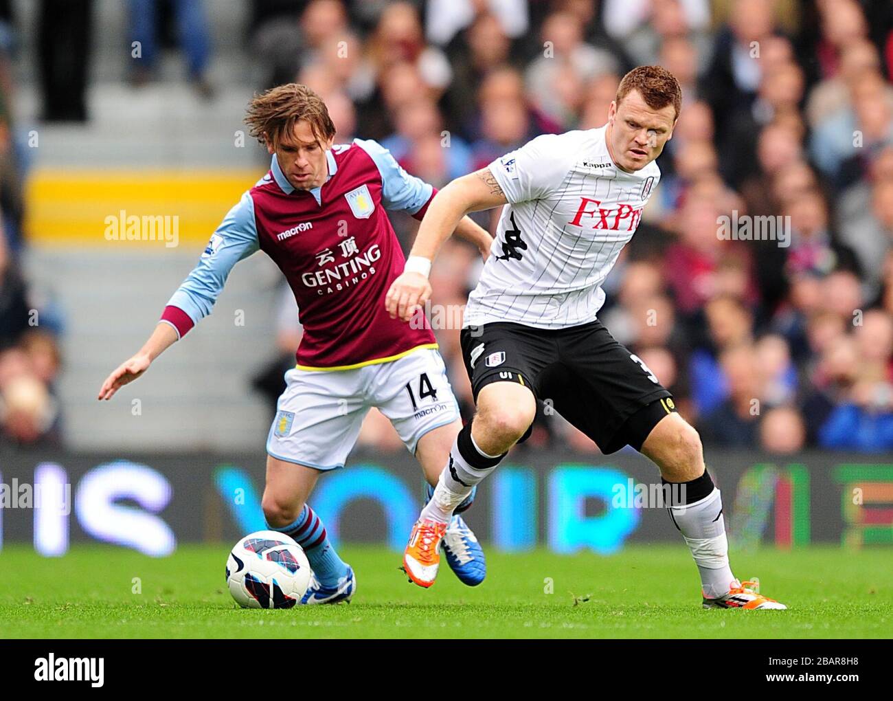 Aston Villa's Brett Holman (left) and Fulham's John Arne Riise battle ...