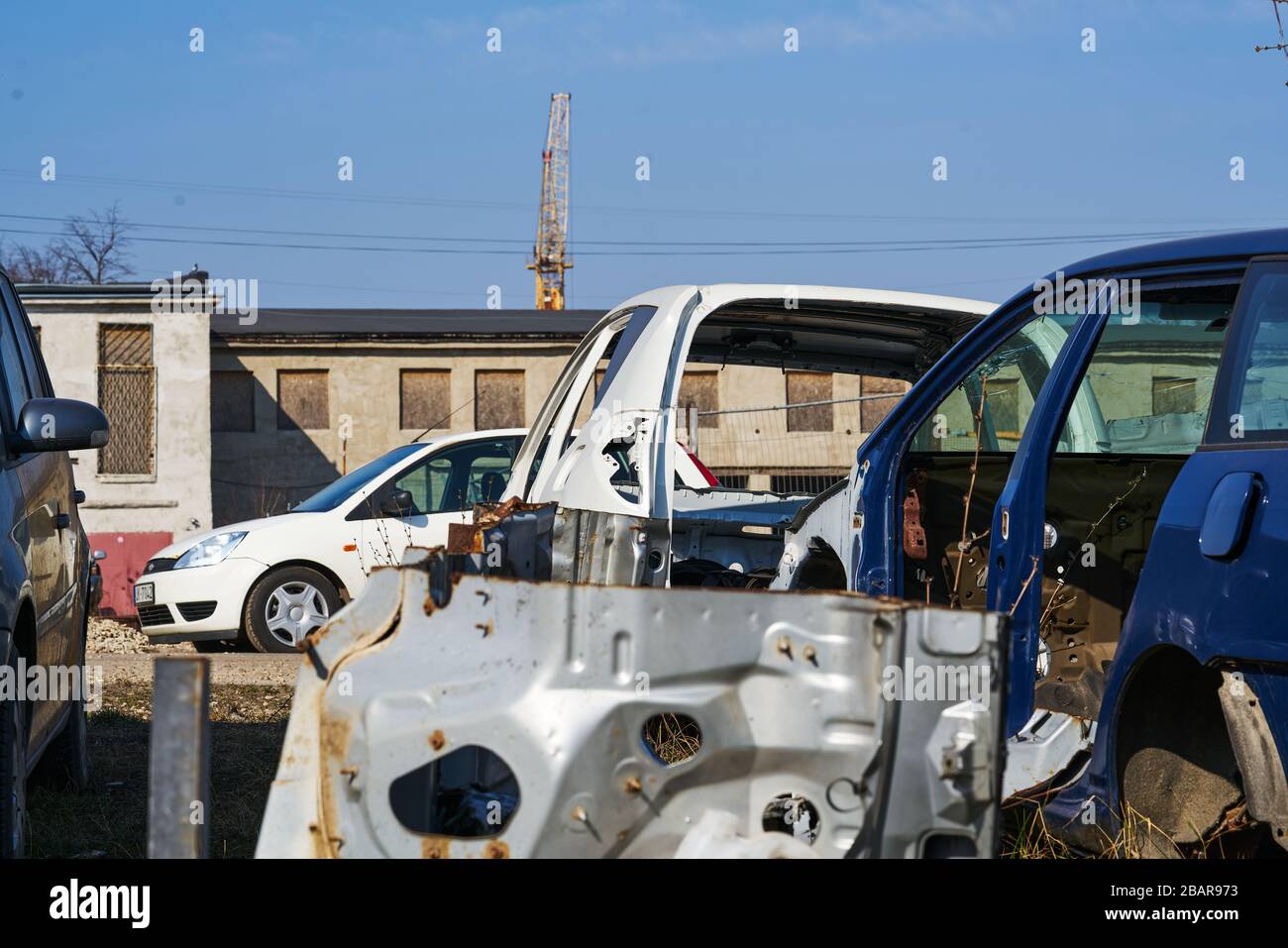 old gray car frame disassembled car with rusty parts on the street near ...
