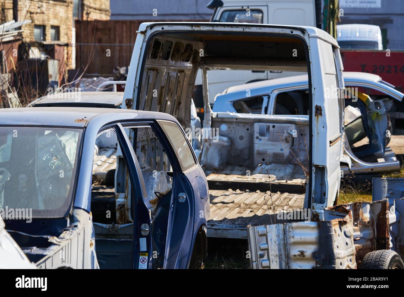 old gray car frame disassembled car with rusty parts on the street near ...