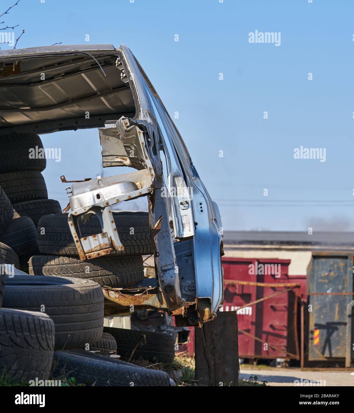 old gray car frame disassembled car with rusty parts on the street near ...