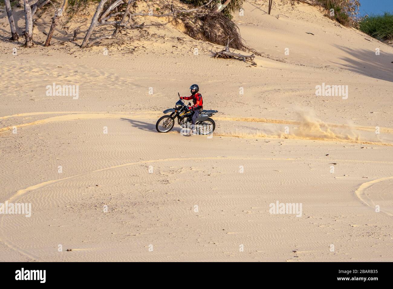 Dirt bike on a sand dune Stock Photo - Alamy