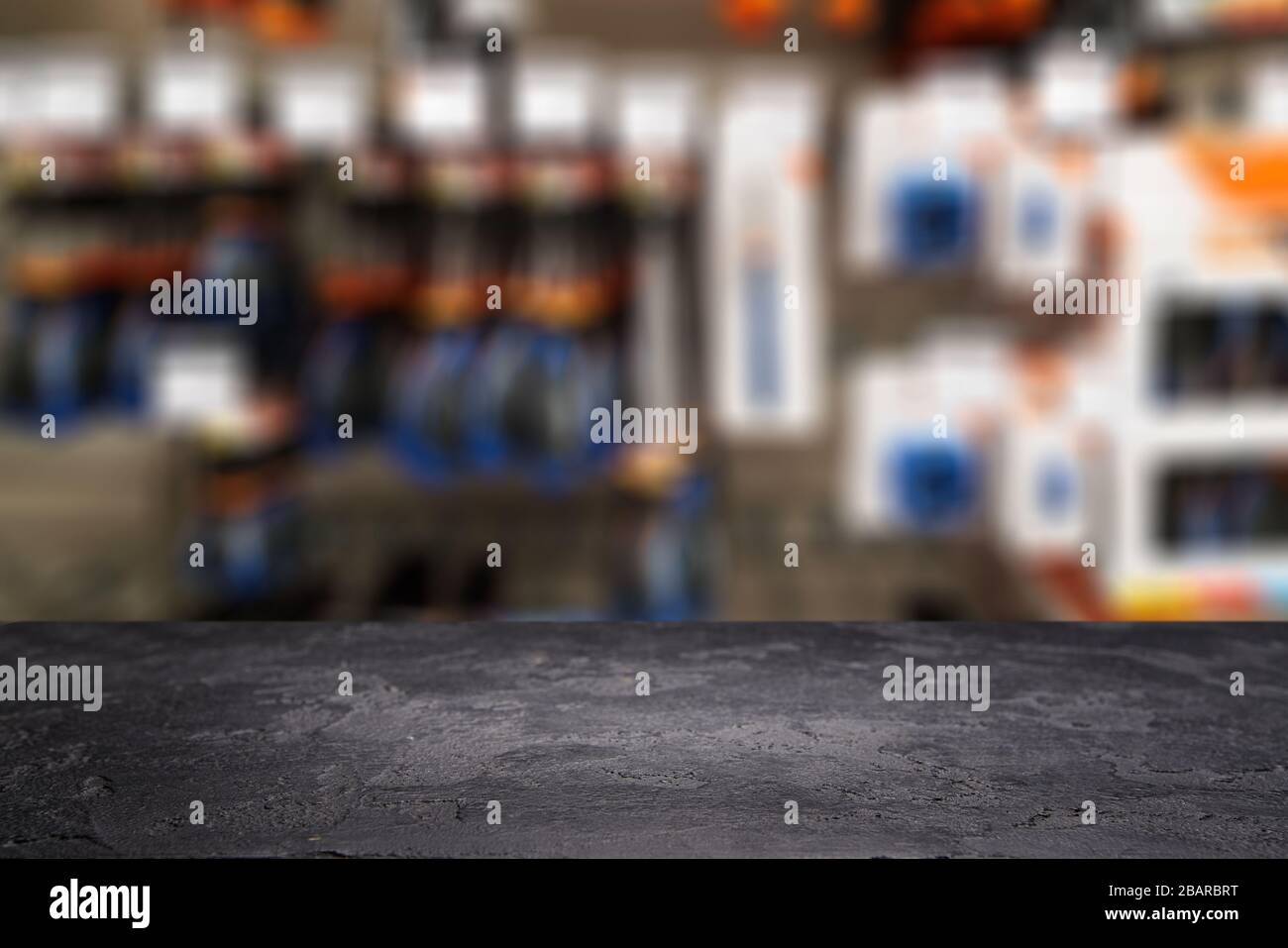 Black stone surface on bokeh background in hardware store. Mock up for ...