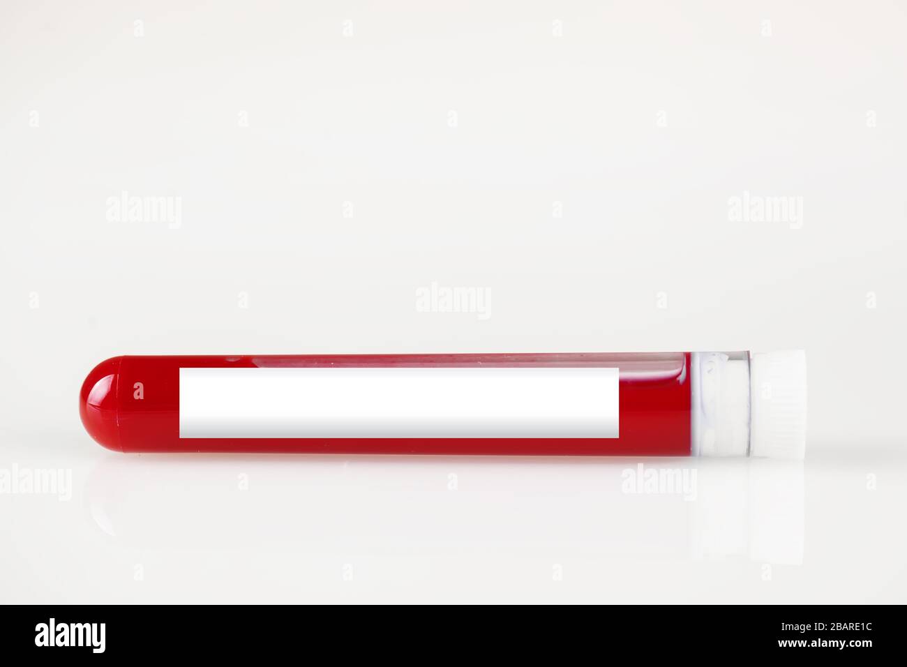Test tube with blood and white sticker on white. Background with copy ...