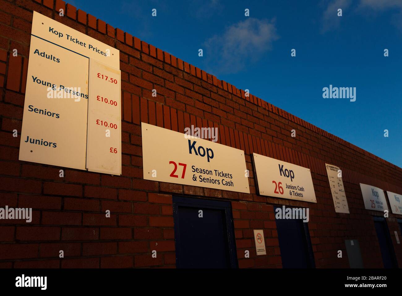 A general view of signage outside the Kop end at Prenton Park, home of ...