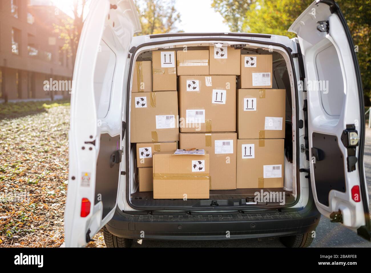 Smiling delivery man with his van Stock Photo - Alamy