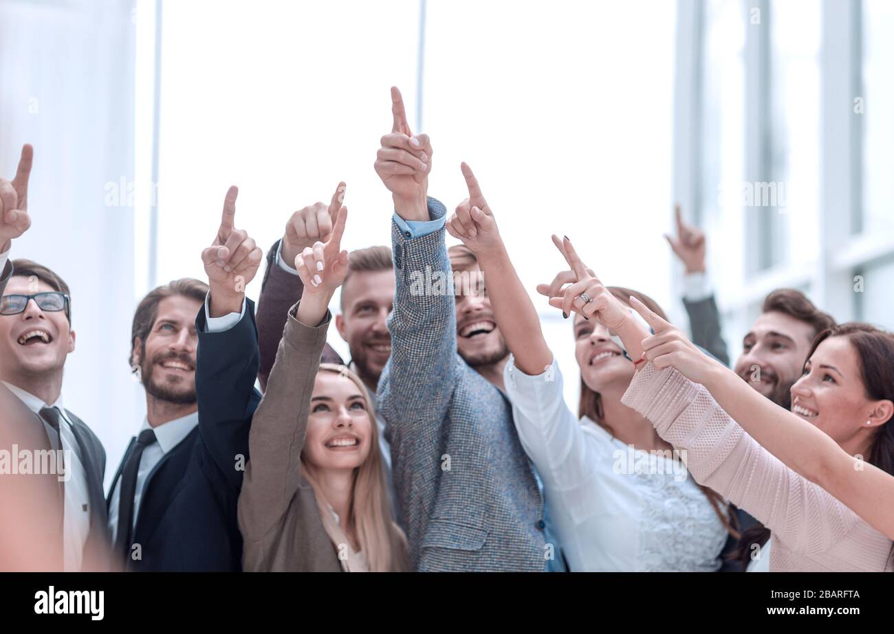 close up. group happy young people, pointing far the upward Stock Photo ...