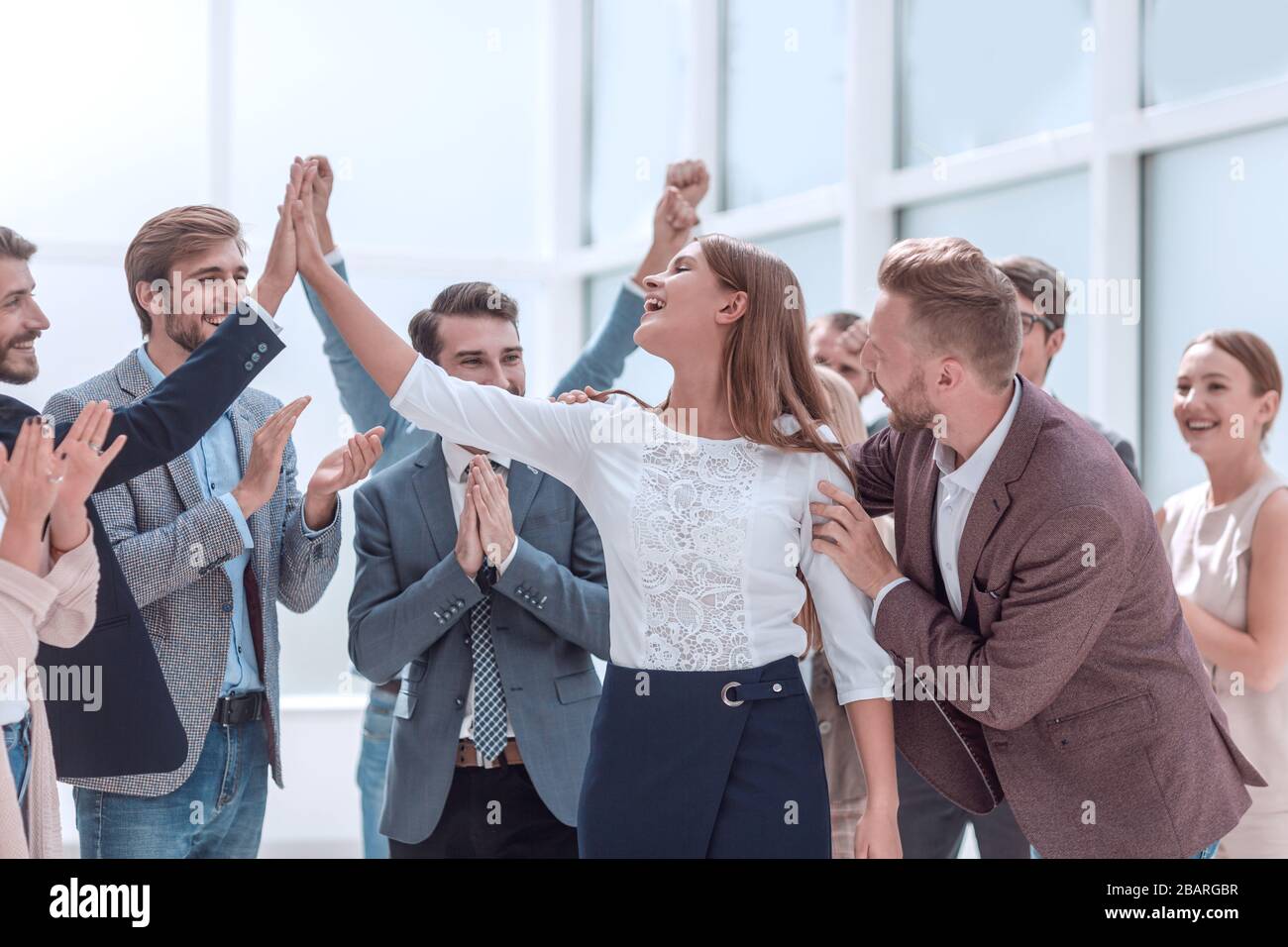 happy business team giving each other a high five Stock Photo - Alamy