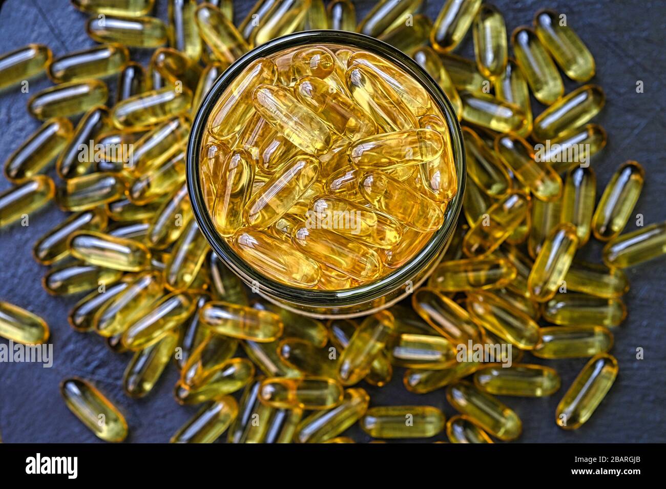 A close up of Omega-3 capsules in a glass jar Stock Photo - Alamy