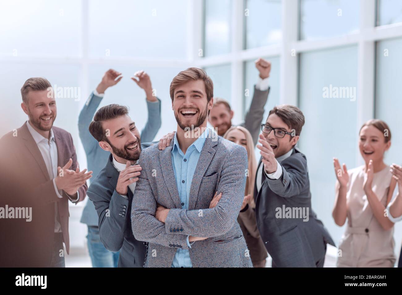 close up. cheerful company employees applauding their colleague Stock ...