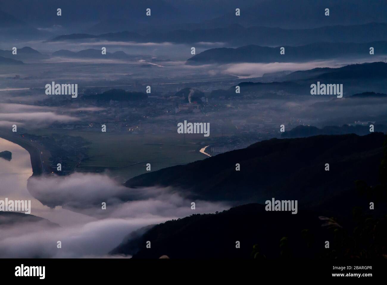 Misty morning sunrise over the bay and city of Toyooka (Toyooka-shi) is ...