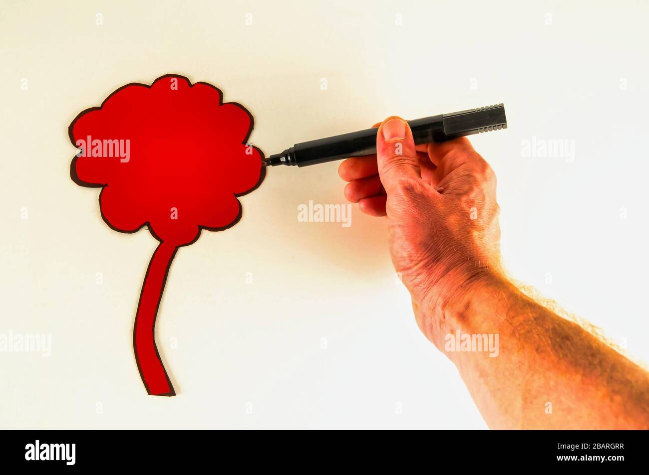 Person drawing a red tree on a white surface Stock Photo - Alamy