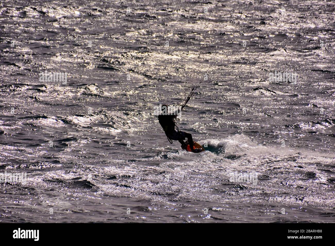 Wide angle shot of a man surfing in the water Stock Photo - Alamy