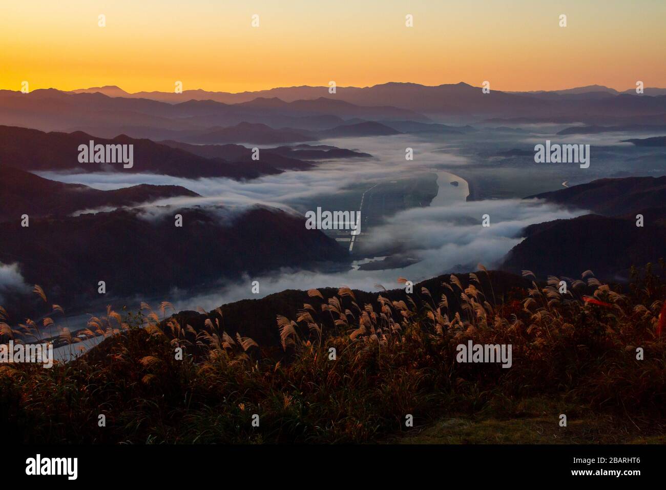 Misty morning sunrise over the bay and city of Toyooka (Toyooka-shi) is ...