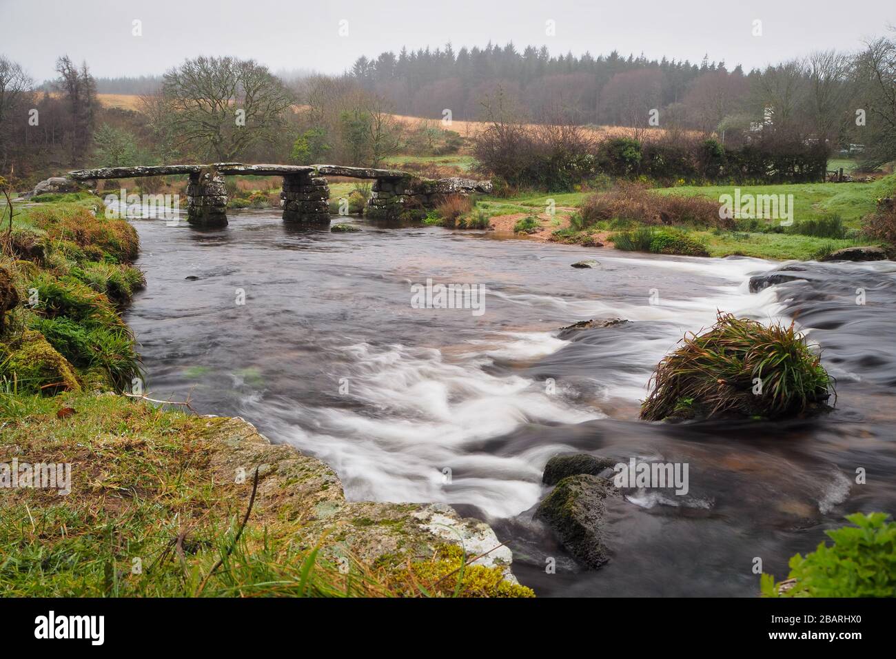 13th century stone clapper bridge built over the East Dart River at ...