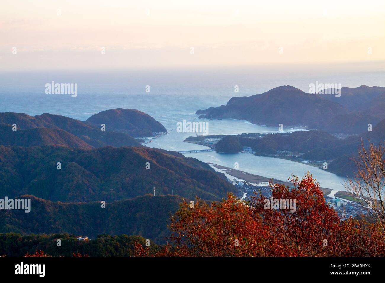 Misty morning sunrise over the bay and city of Toyooka (Toyooka-shi) is ...