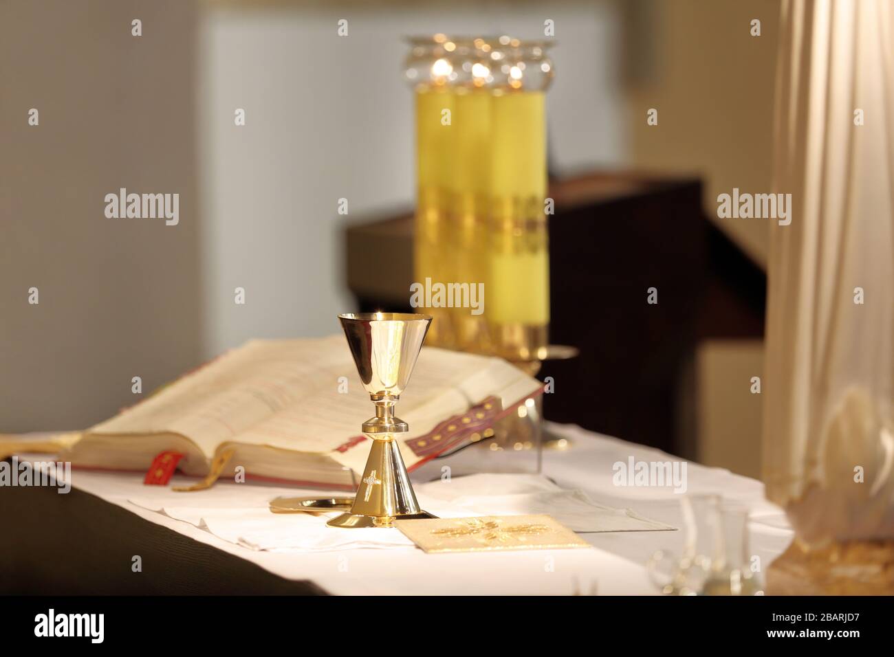 Chalice on the altar and Roman Missal in the background Stock Photo - Alamy