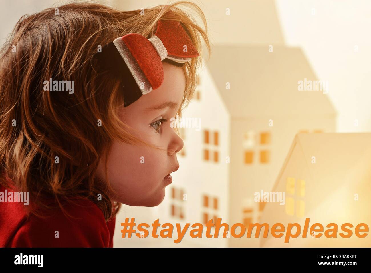 Stay at home please The child is playing toy houses at home during ...