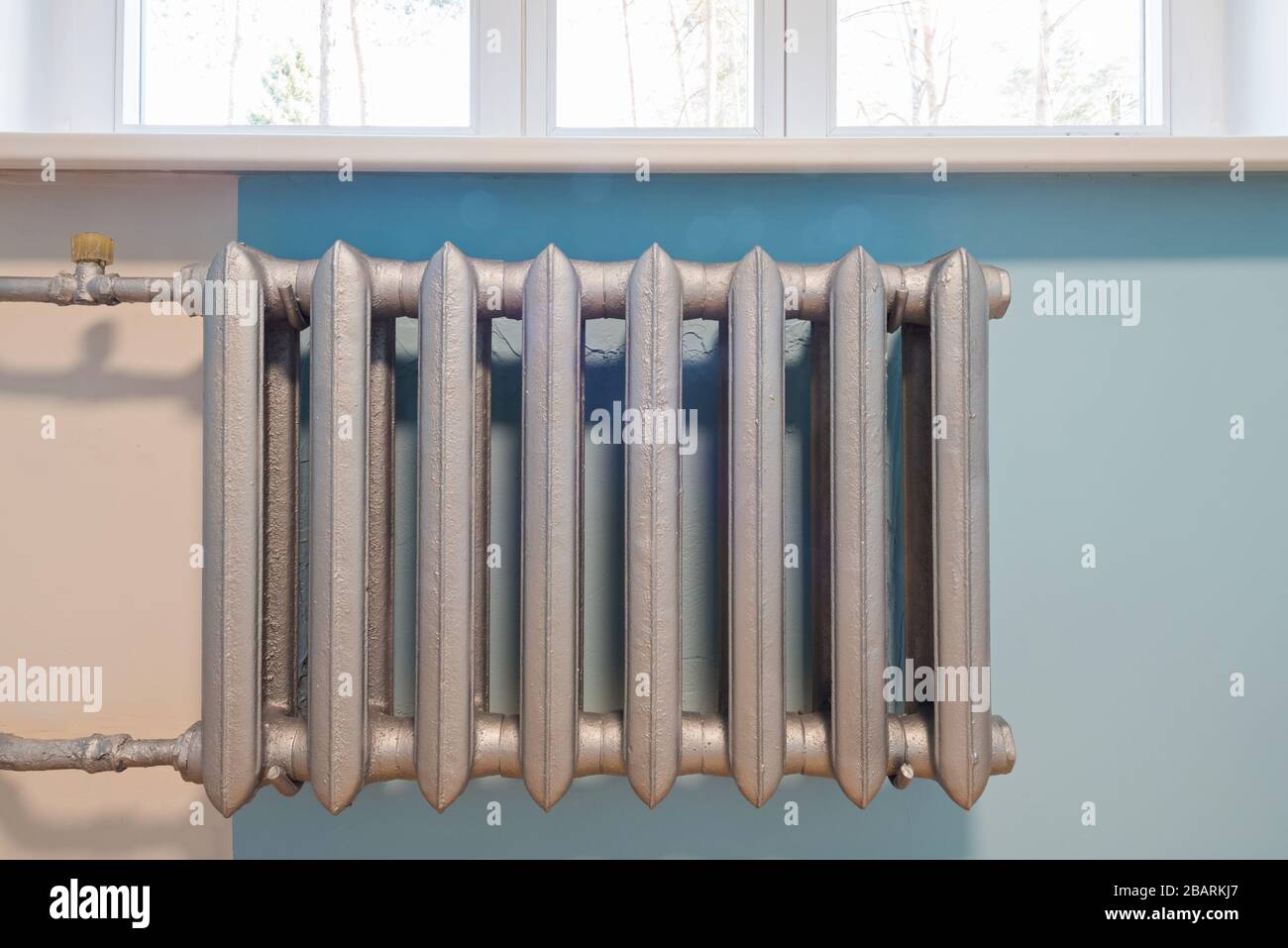 Cast iron radiator of water on the wall Stock Photo - Alamy